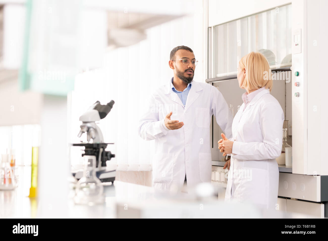 Discussing scientific project in laboratory Stock Photo - Alamy