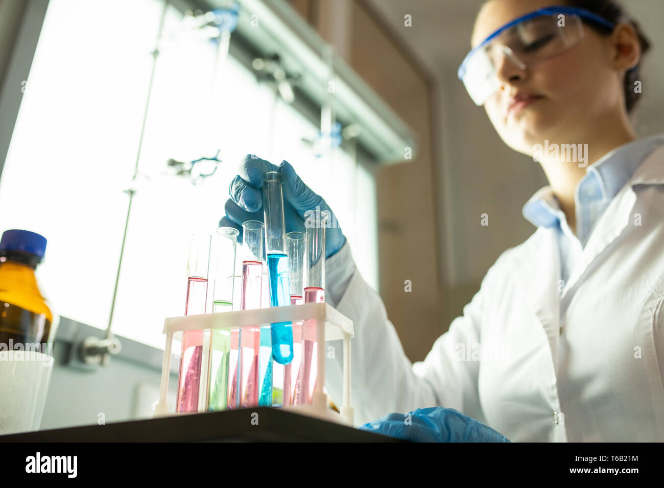 Laboratory worker sorting test tubes with colorful liquids Stock Photo ...