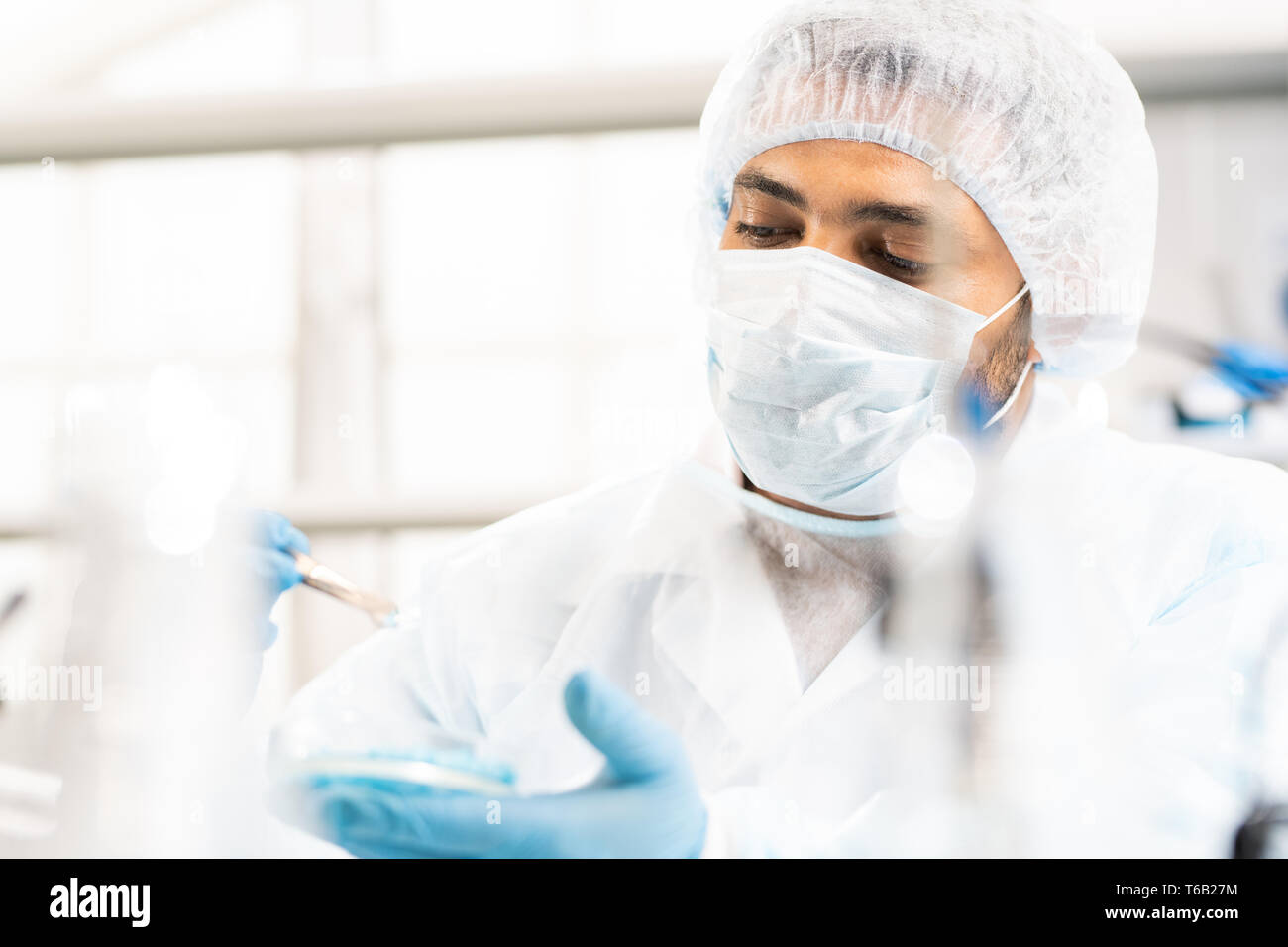 Arabian laboratory worker studying virus Stock Photo - Alamy