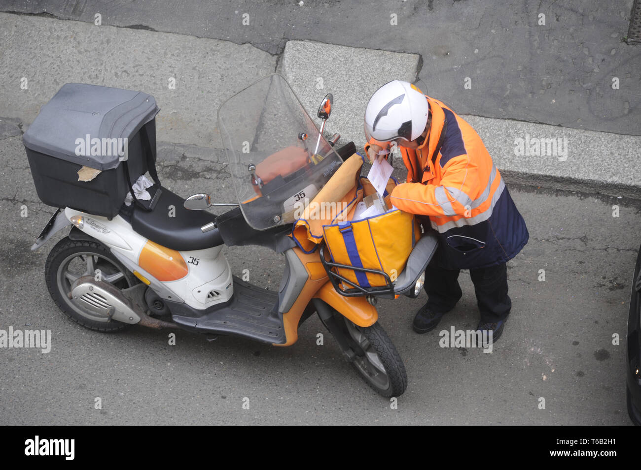 Milan (Italy), postman at work Stock Photo - Alamy