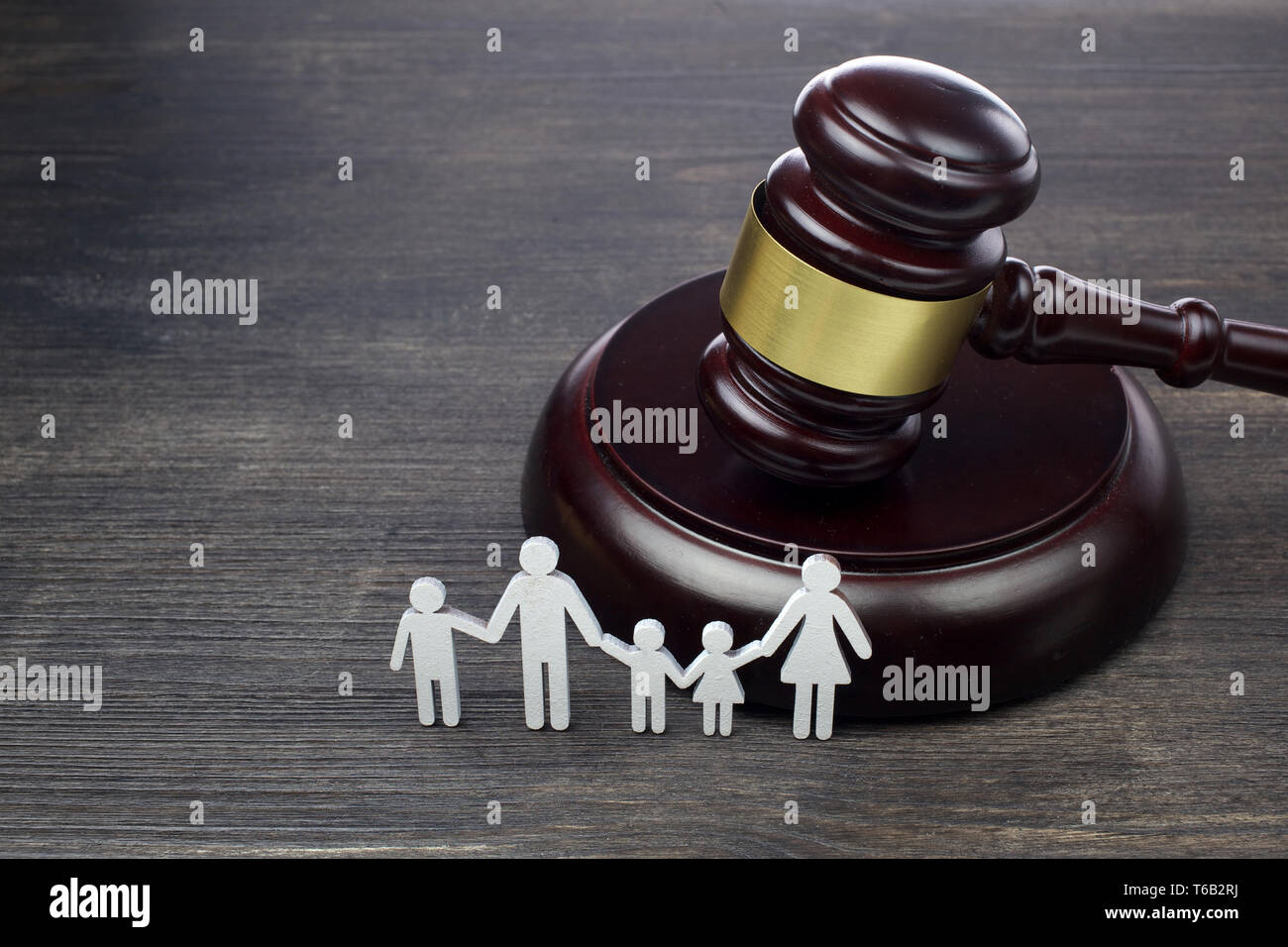 Family figure and gavel on wooden table. Family law concept Stock Photo ...