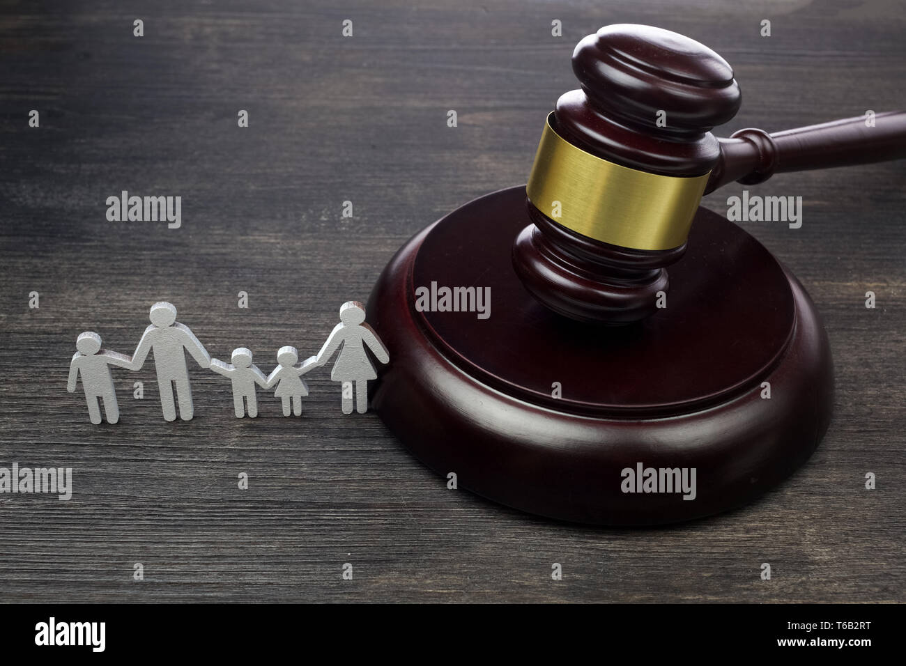 Family figure and gavel on wooden table. Family law concept Stock Photo ...