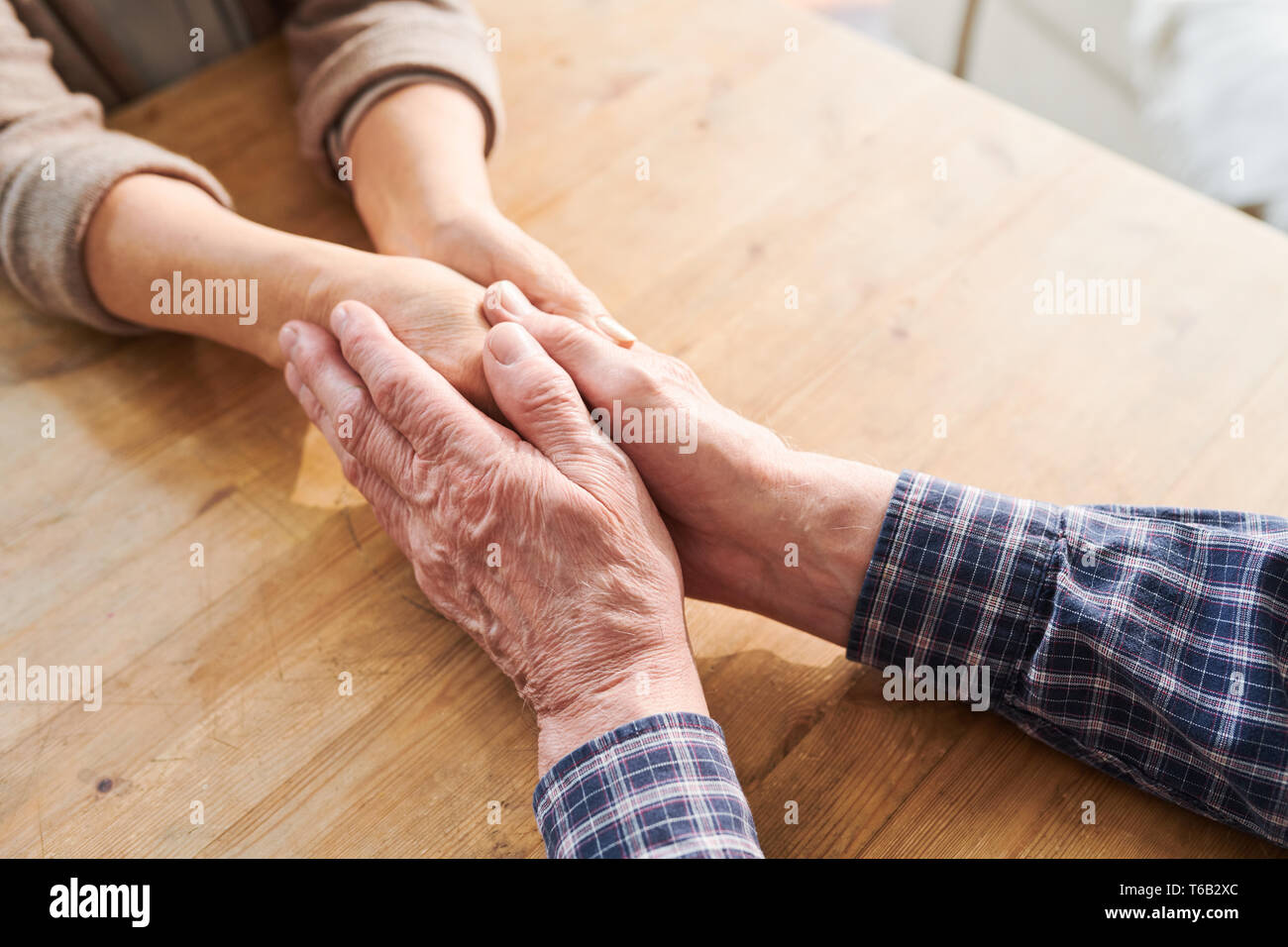 Hand in hand with one another Stock Photo - Alamy