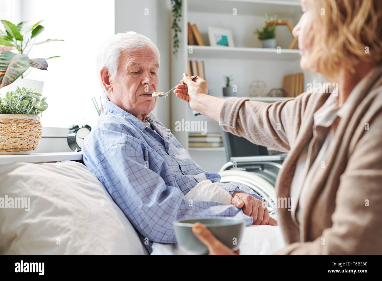 Feeding sick man Stock Photo - Alamy