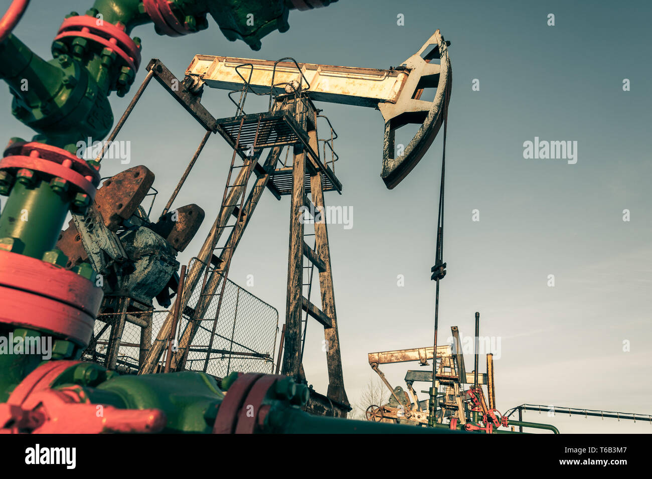 Oil pump jack and wellhead in the oilfield Stock Photo - Alamy
