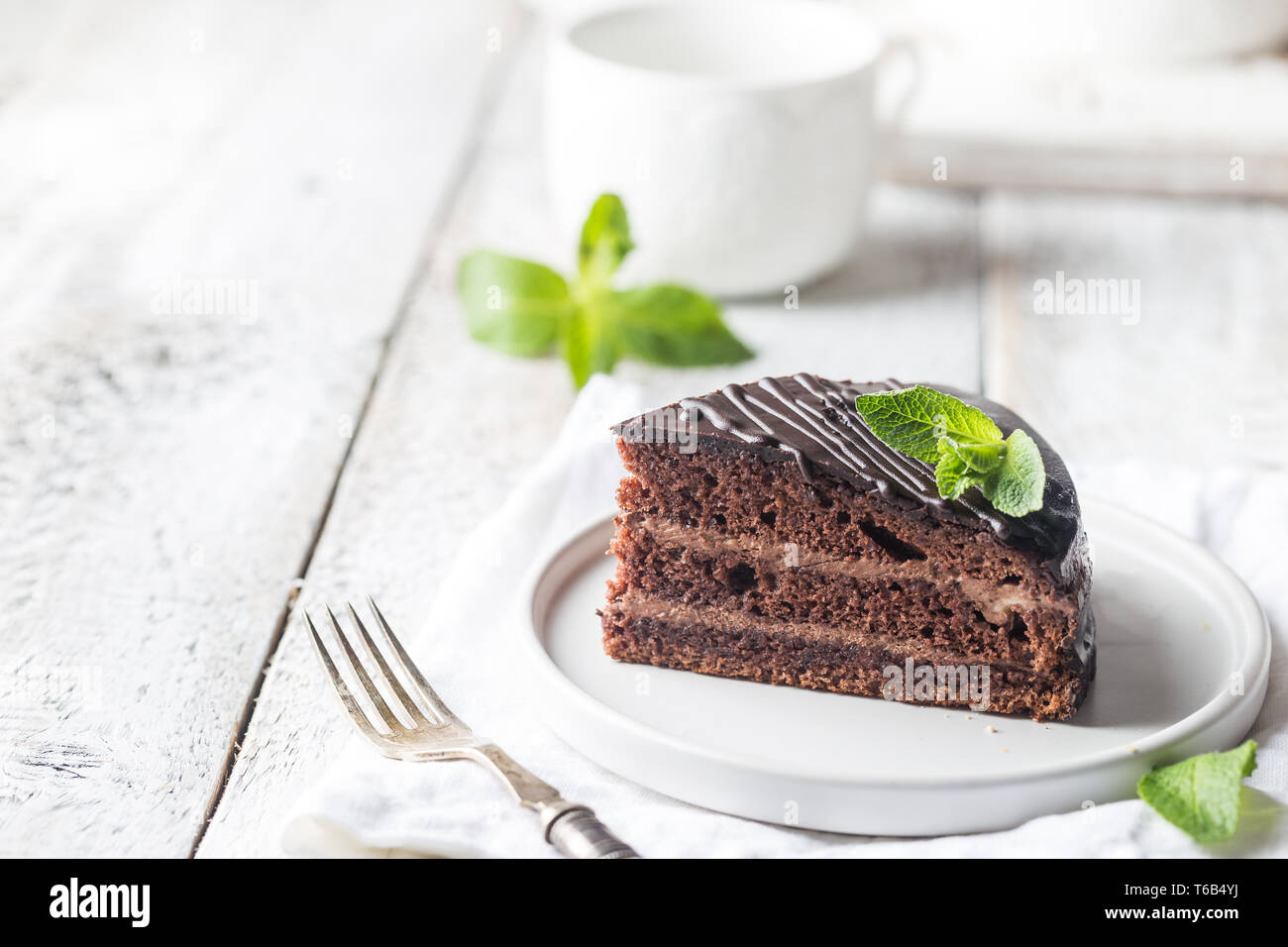 Delicious chocolate Prague cake on plate over white background Stock ...