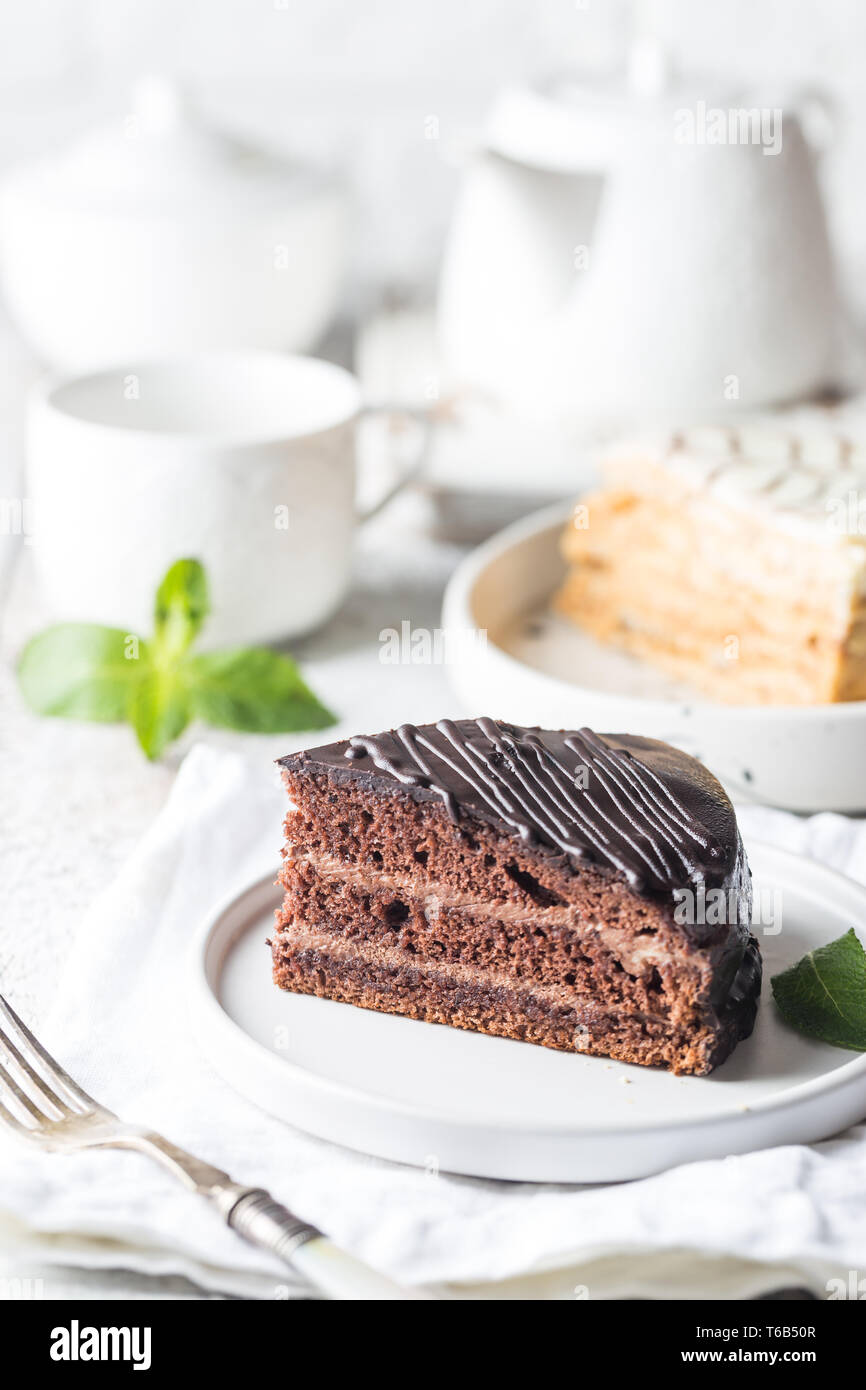 Delicious chocolate Prague cake on plate over white background Stock ...