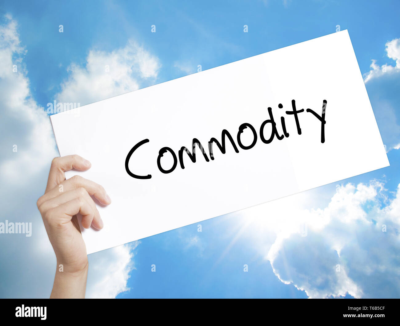 Commodity Sign on white paper. Man Hand Holding Paper with text ...