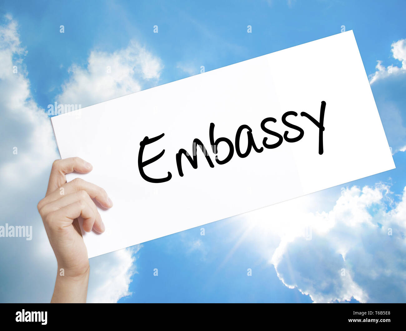 Embassy Sign on white paper. Man Hand Holding Paper with text. Isolated ...