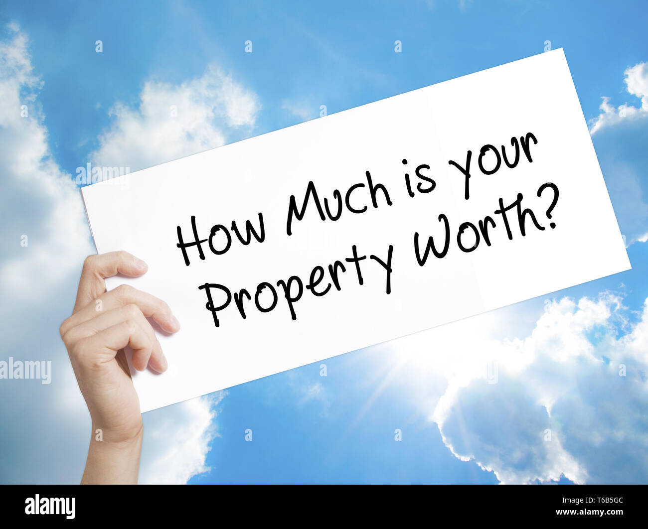 How Much is your Property Worth? Sign on white paper. Man Hand Holding ...
