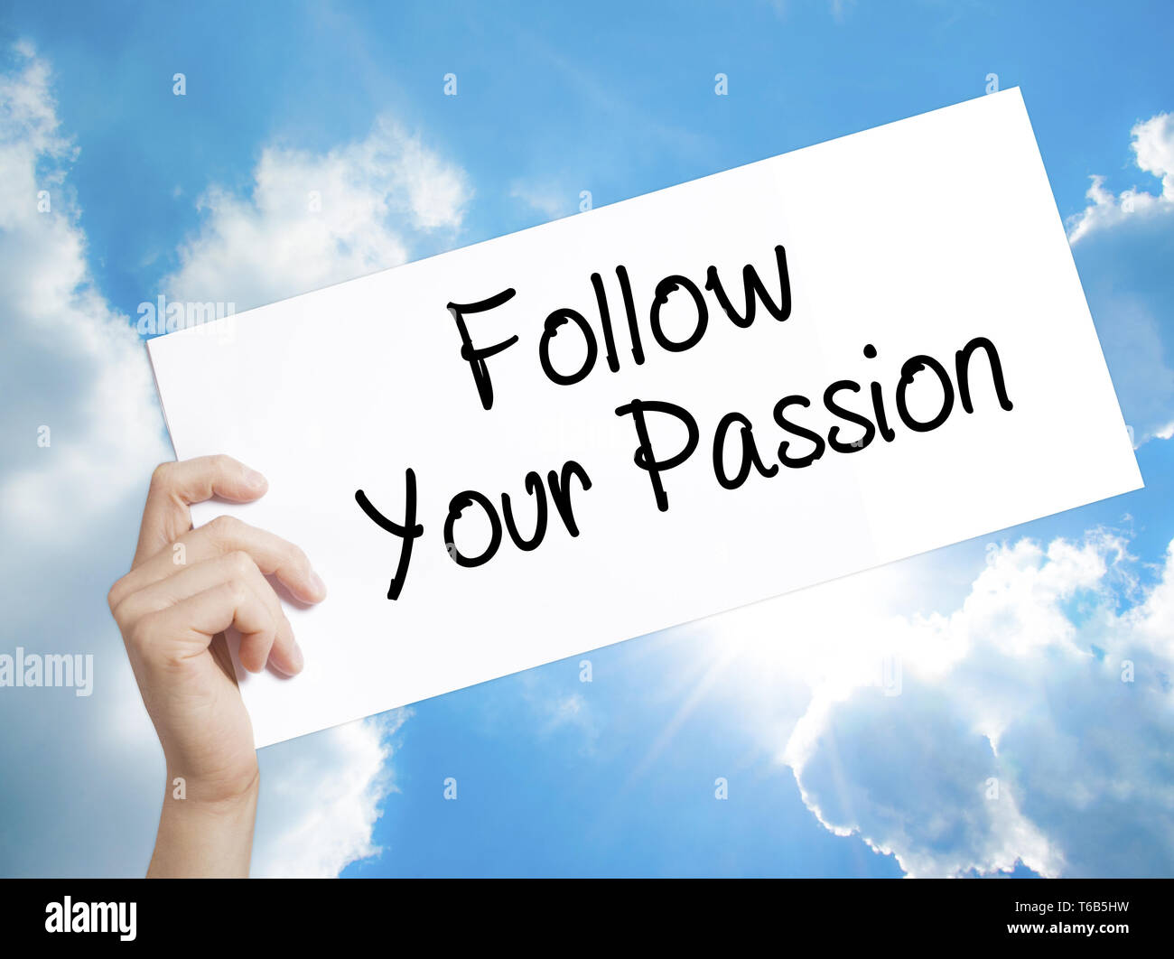 Follow Your Passion Sign on white paper. Man Hand Holding Paper with ...