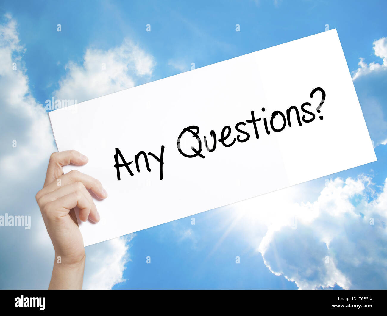 Any Questions? Sign on white paper. Man Hand Holding Paper with text ...