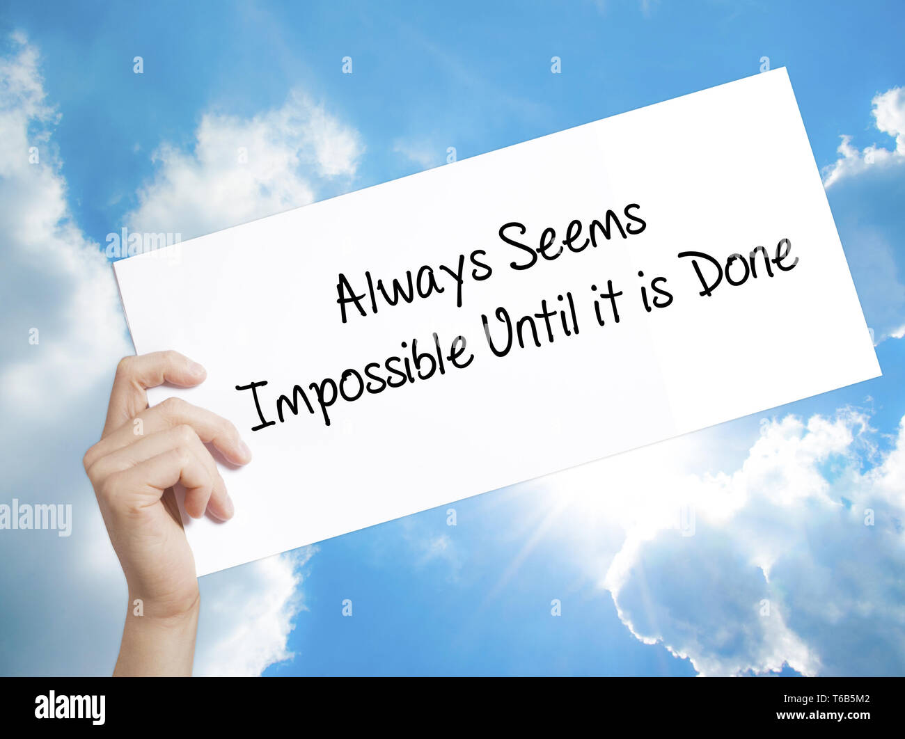 Always Seems Impossible Until it is Done Sign on white paper. Man Hand ...