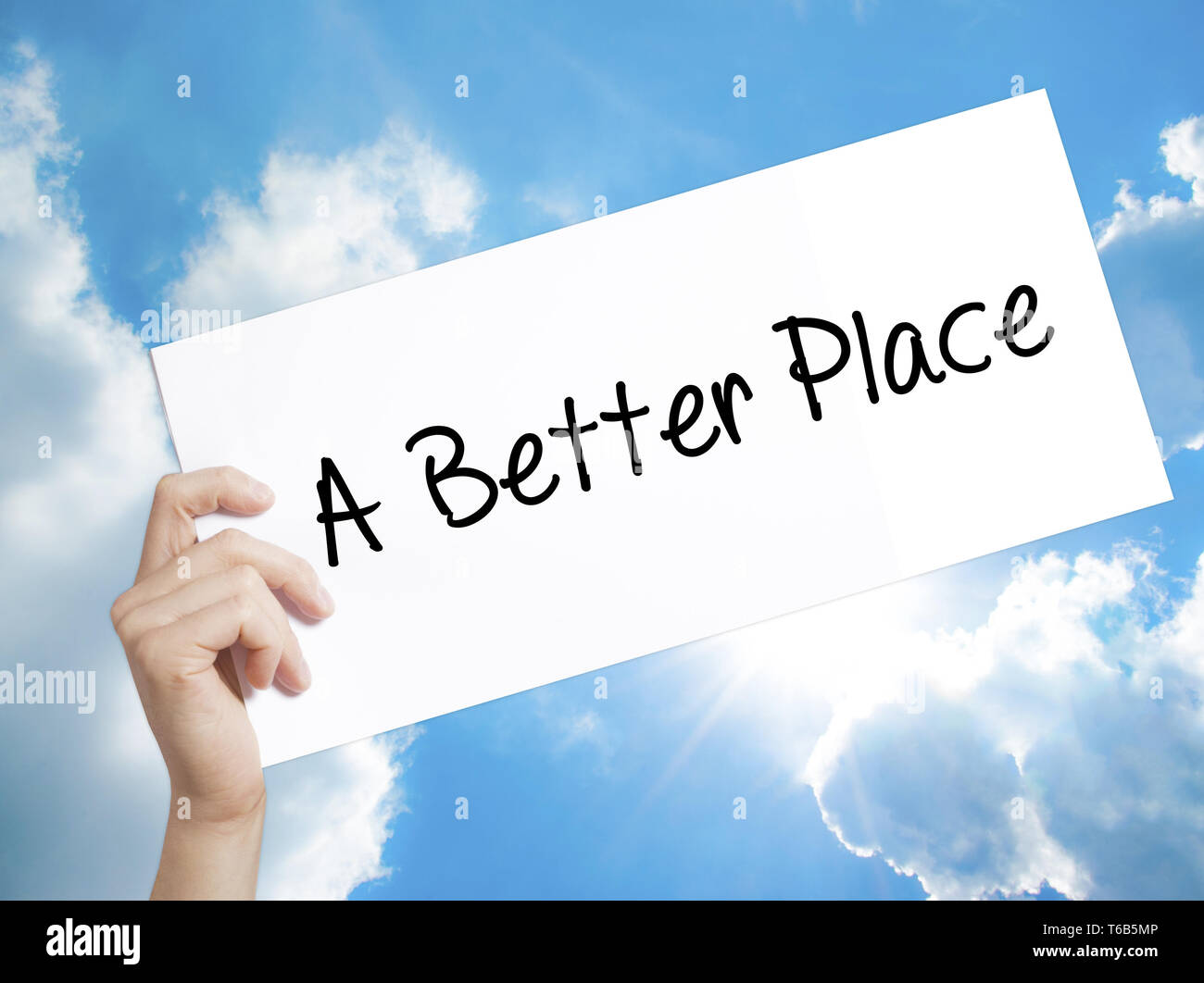 A Better Place Sign on white paper. Man Hand Holding Paper with text ...