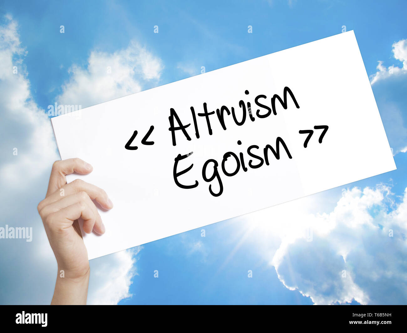 Altruism - Egoism Sign on white paper. Man Hand Holding Paper with text ...