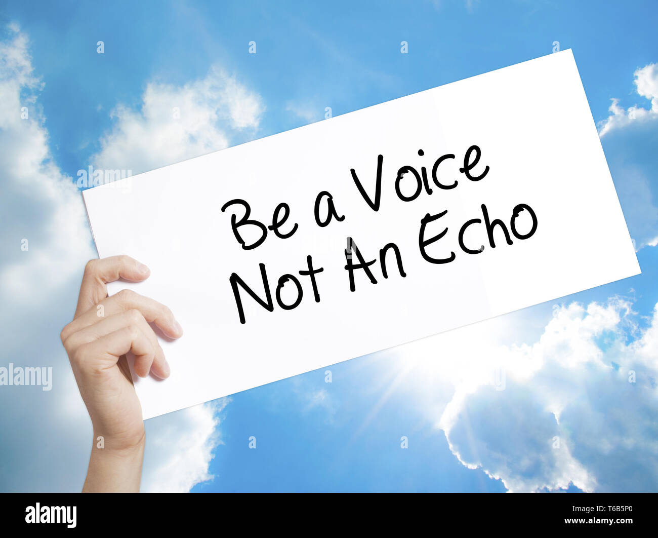 Be a Voice Not An Echo Sign on white paper. Man Hand Holding Paper with ...