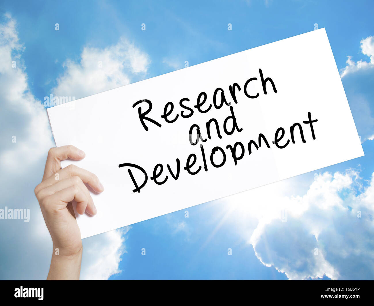 Research and Development Sign on white paper. Man Hand Holding Paper ...