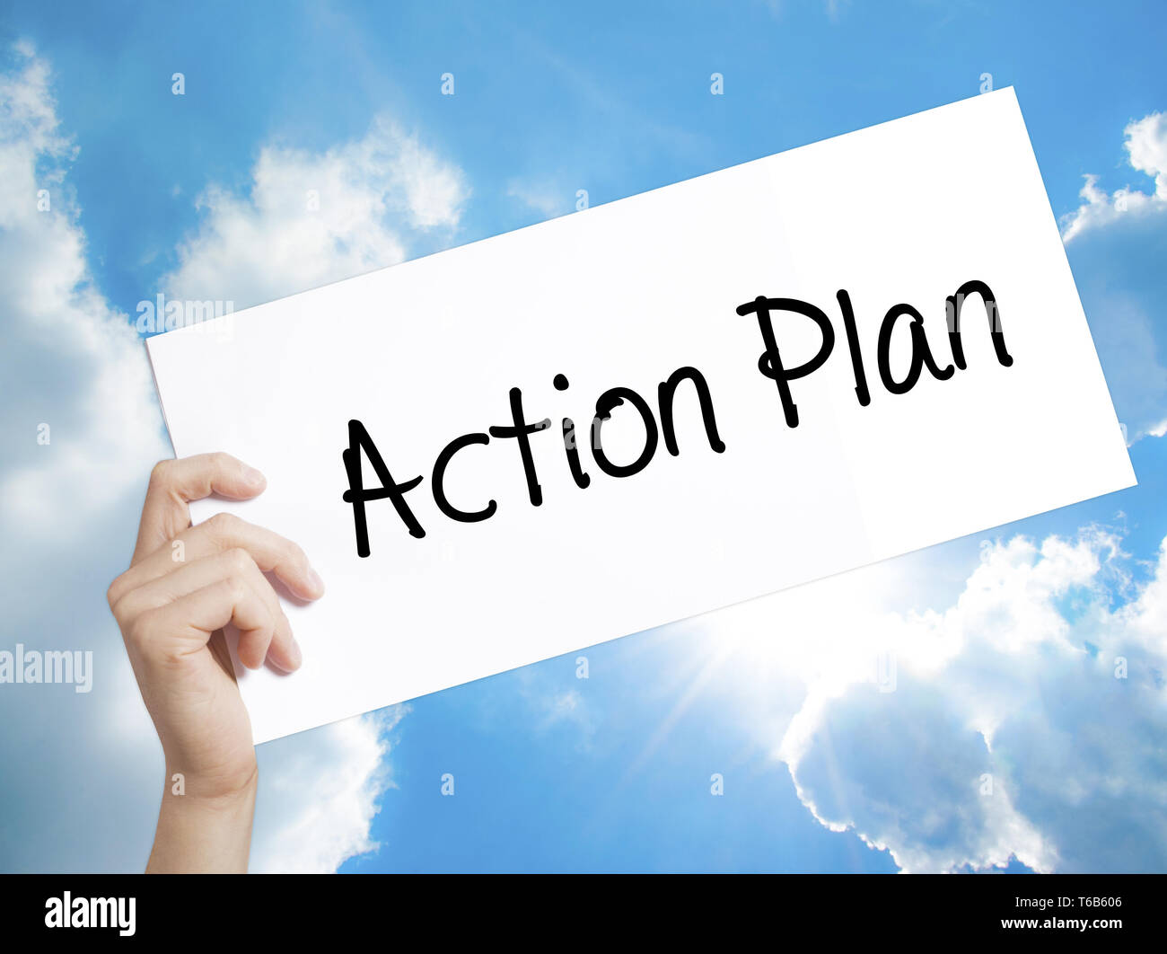Action Plan Sign on white paper. Man Hand Holding Paper with text ...