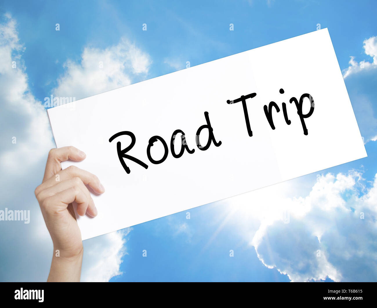Road Trip Sign on white paper. Man Hand Holding Paper with text ...