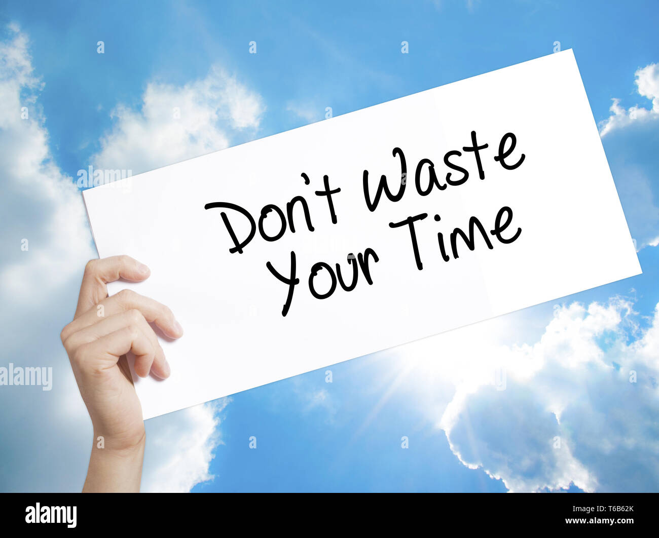 Don't Waste Your Time Sign on white paper. Man Hand Holding Paper with ...