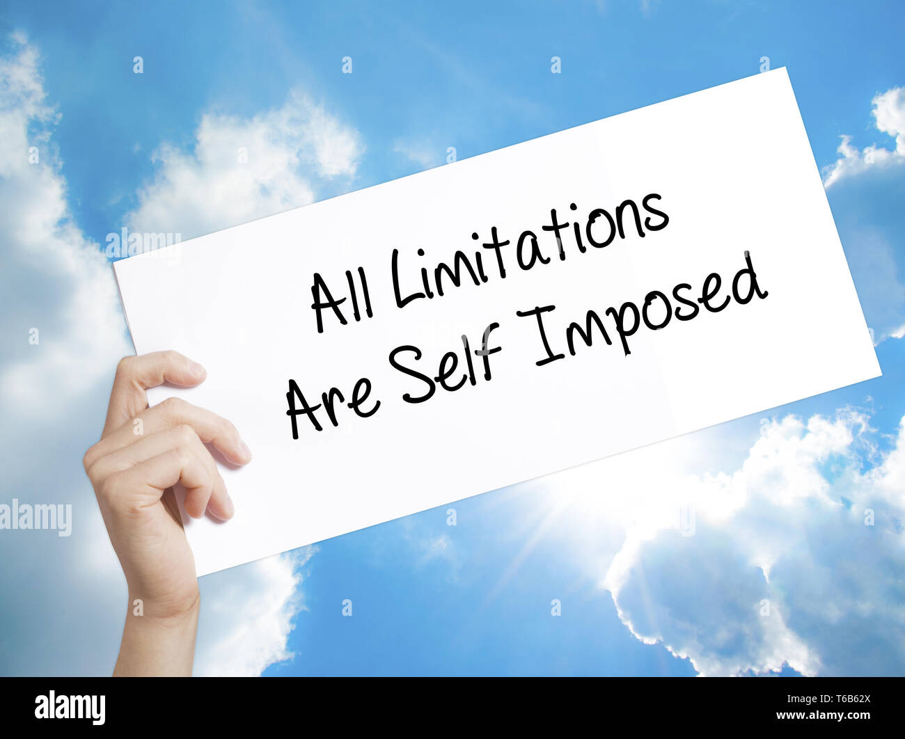 All Limitations Are Self Imposed Sign on white paper. Man Hand Holding ...