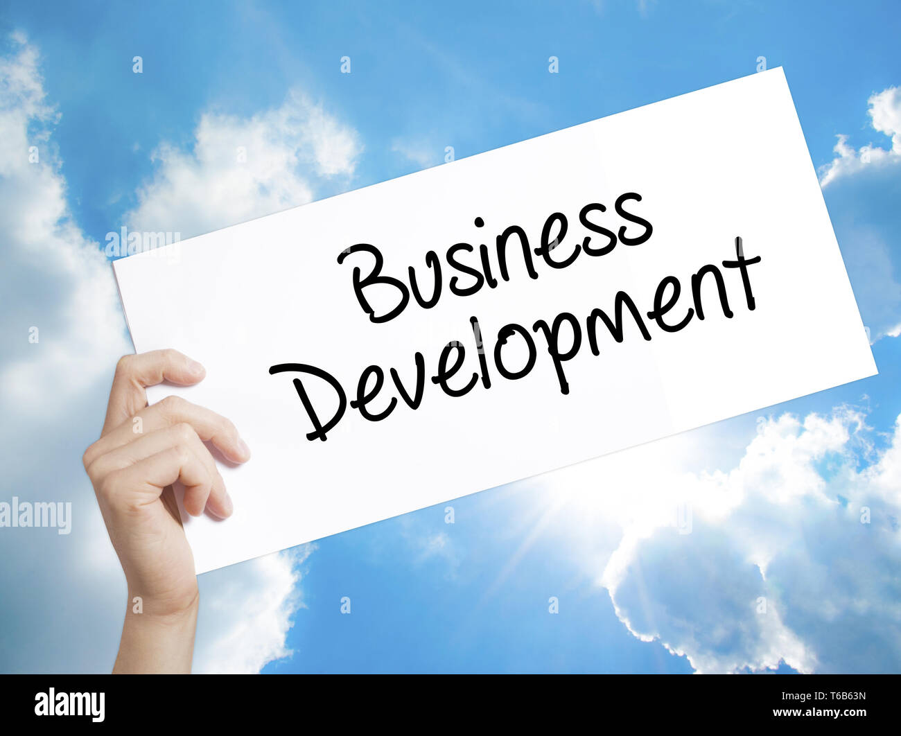 Business Development Sign on white paper. Man Hand Holding Paper with ...