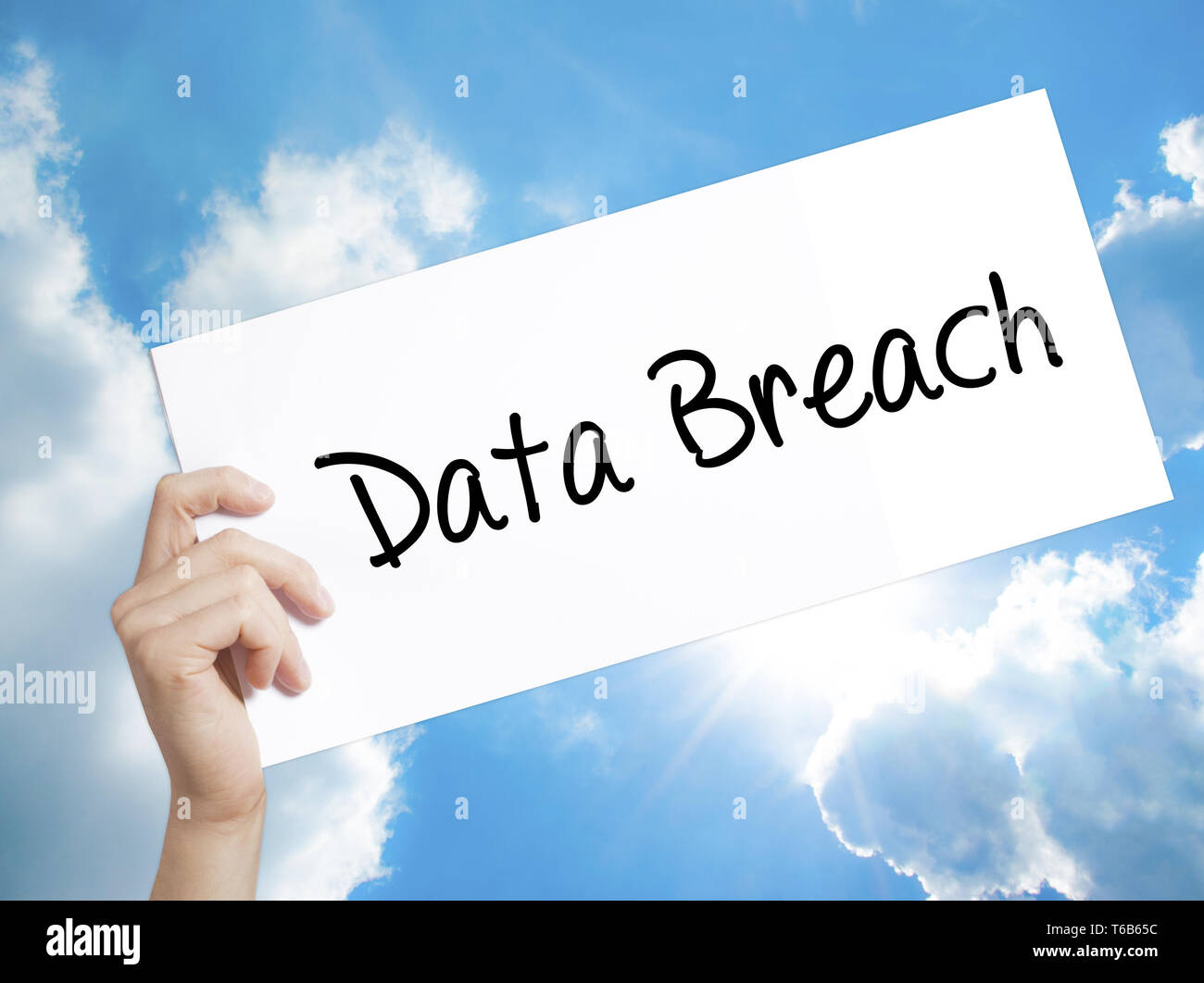 Data Breach Sign on white paper. Man Hand Holding Paper with text ...