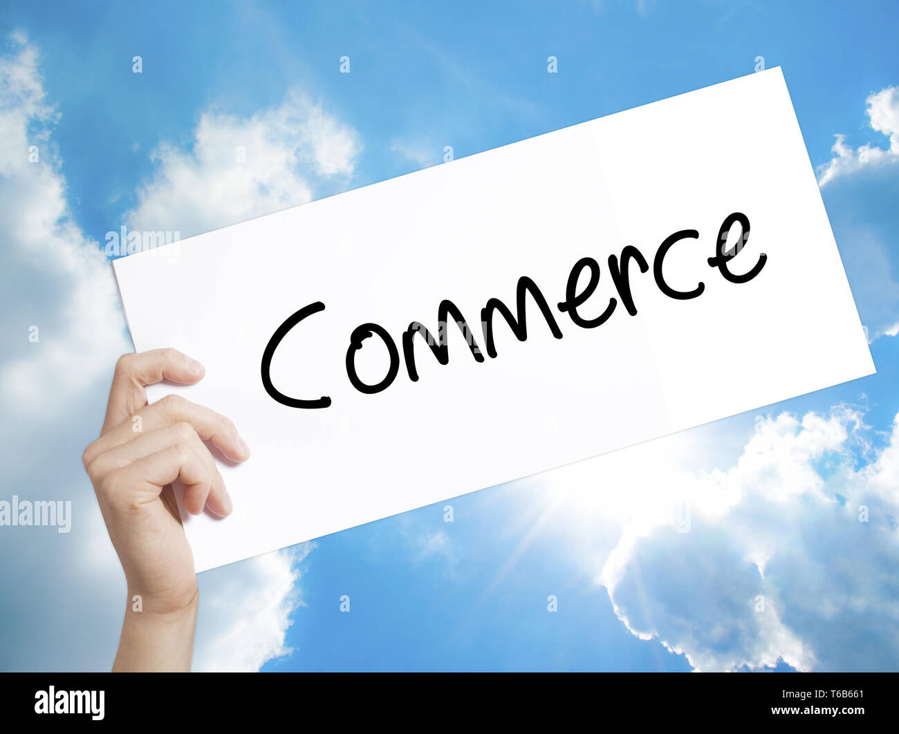 Commerce Sign on white paper. Man Hand Holding Paper with text ...
