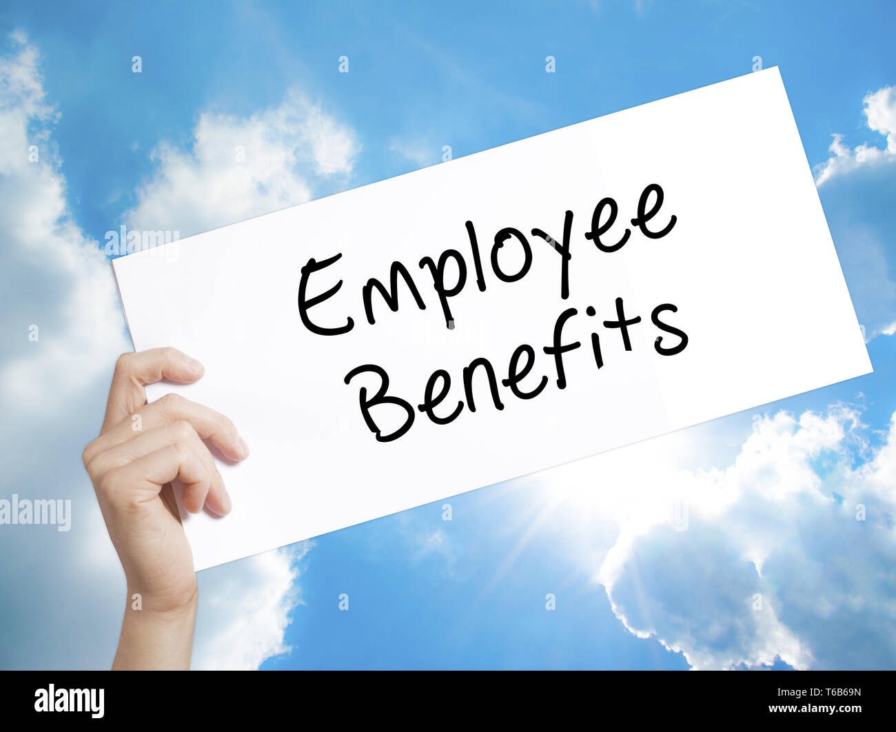 Employee Benefits Sign on white paper. Man Hand Holding Paper with text ...