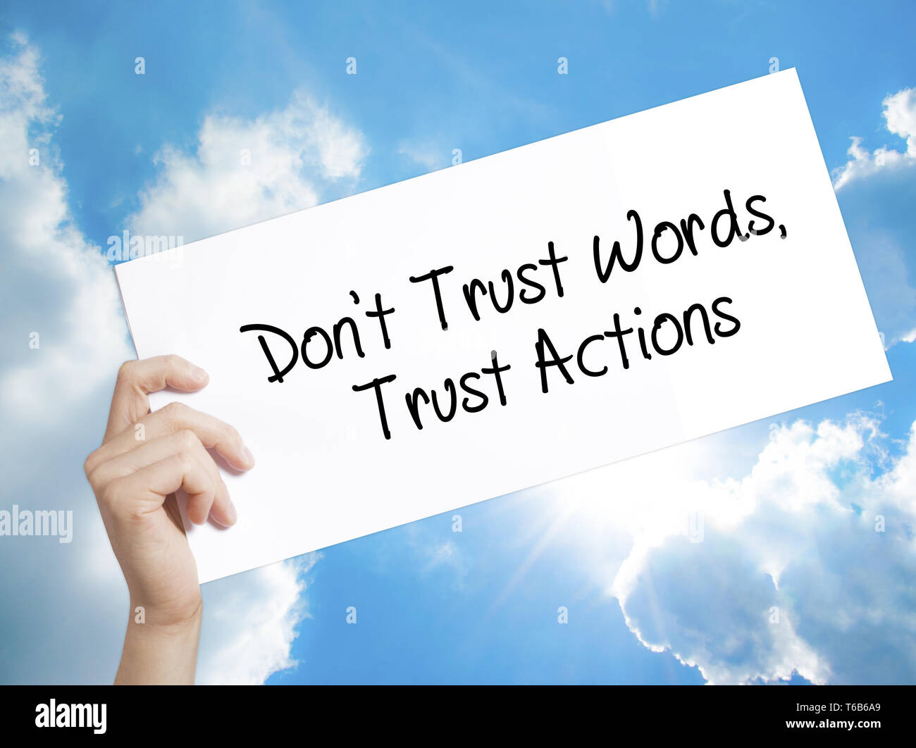 Don't Trust Words, Trust Actions Sign on white paper. Man Hand Holding ...