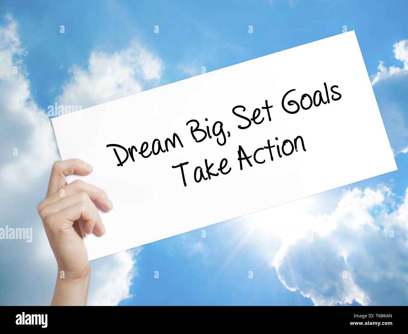Dream Big Set Goals Take Action Sign on white paper. Man Hand Holding ...