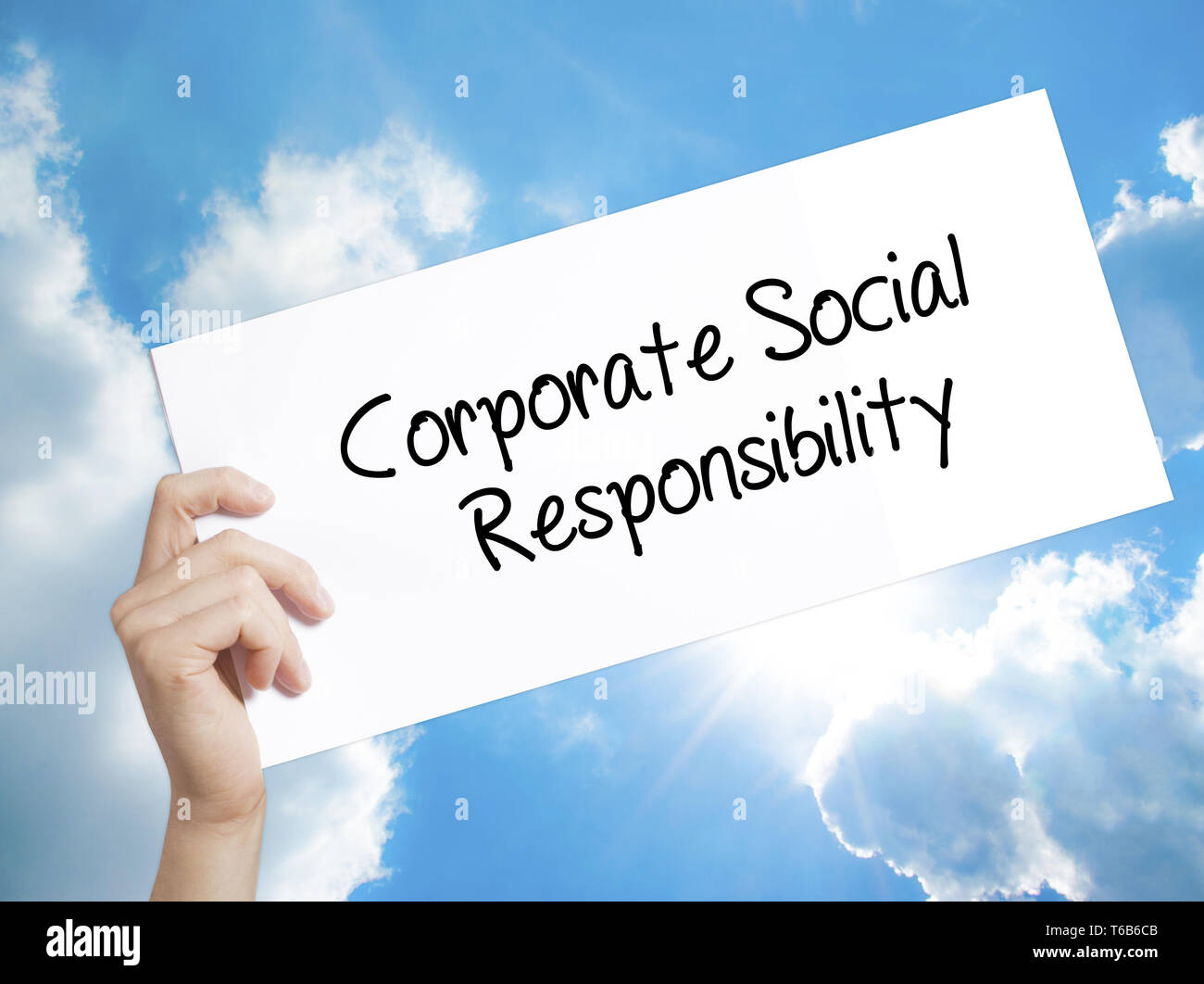Corporate Social Responsibility Sign on white paper. Man Hand Holding ...