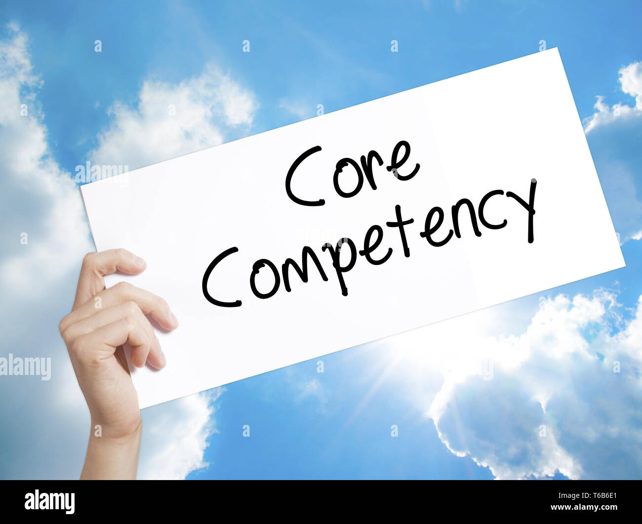 Core Competency Sign on white paper. Man Hand Holding Paper with text ...