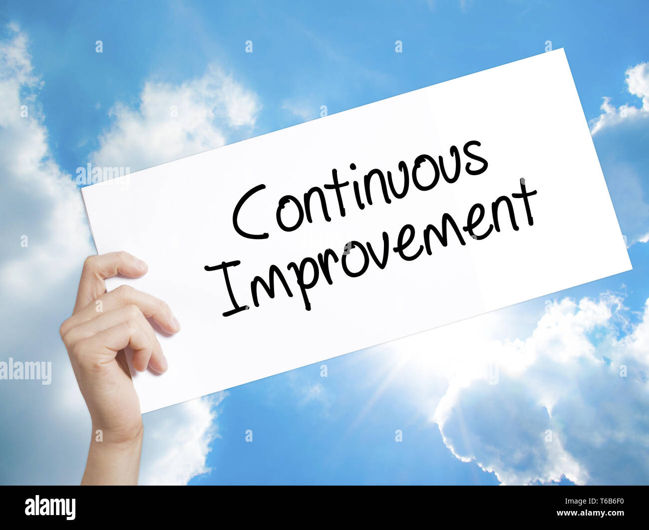 Continuous Improvement Sign on white paper. Man Hand Holding Paper with ...