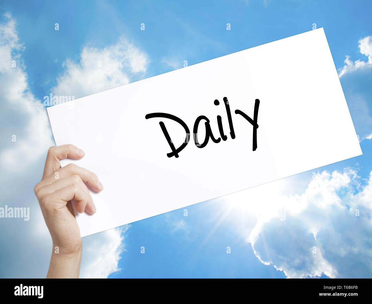 Daily Sign on white paper. Man Hand Holding Paper with text. Isolated ...