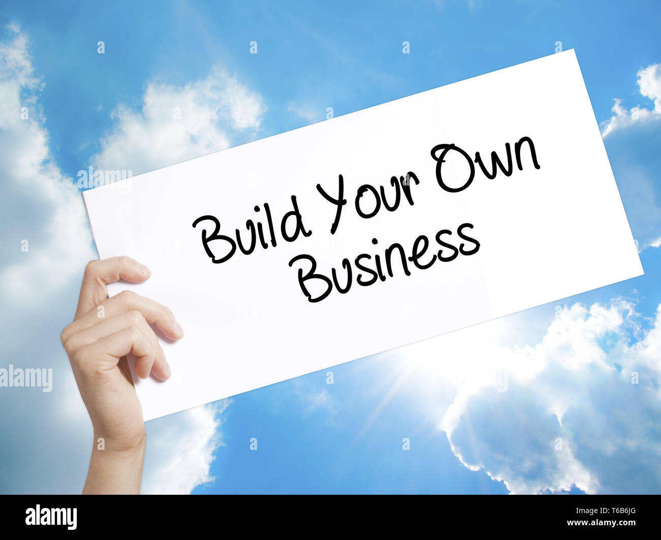 Build Your Own Business Sign on white paper. Man Hand Holding Paper ...