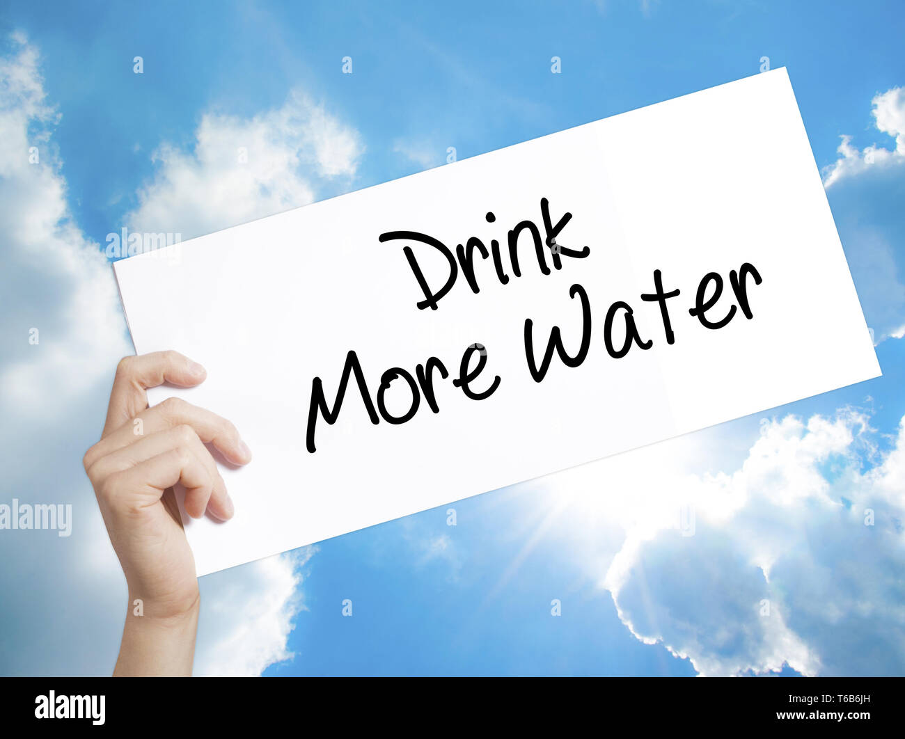 Drink More Water Sign on white paper. Man Hand Holding Paper with text ...