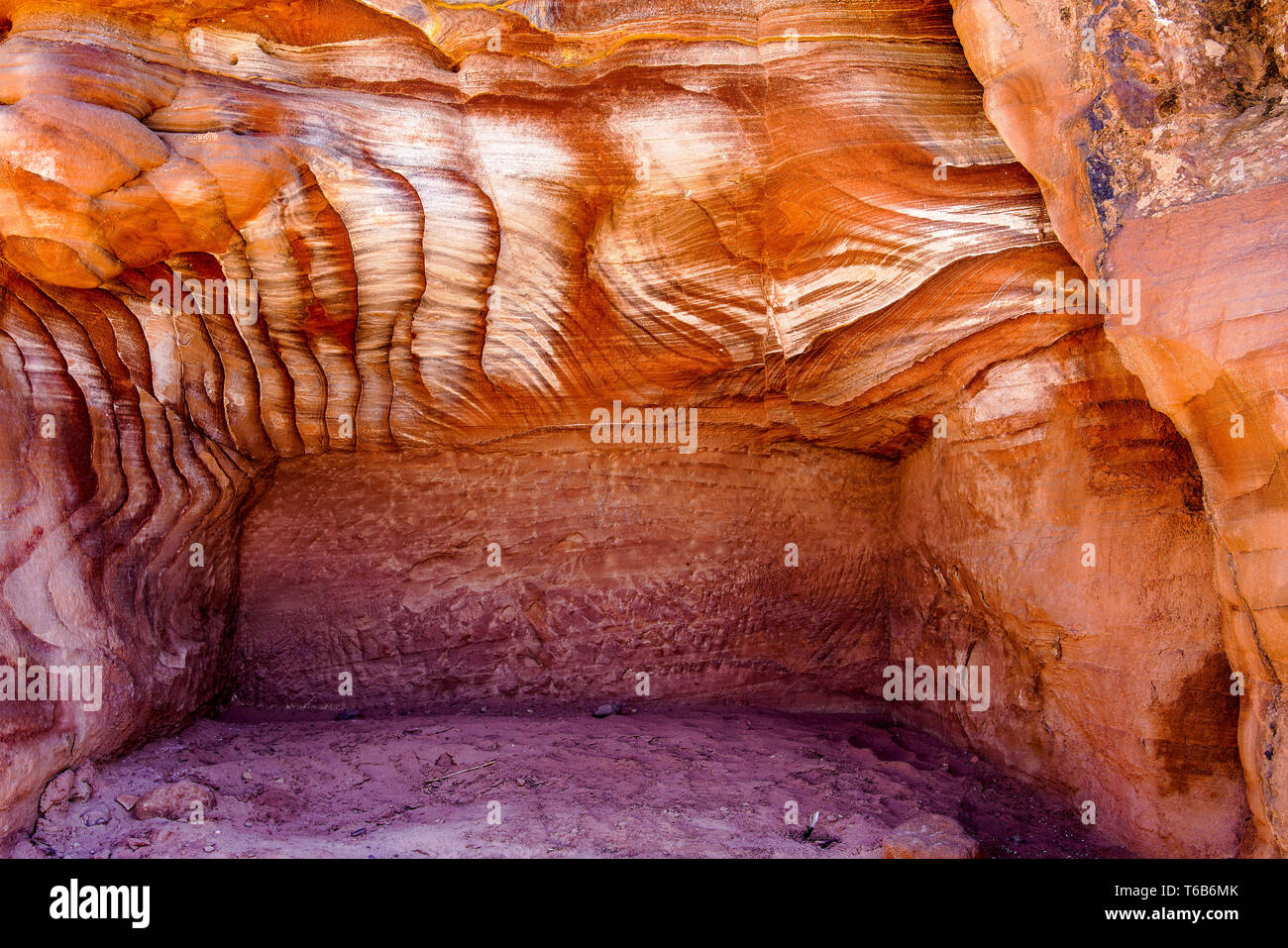 Colorful sandstone inside a tomb, Rose Red Rock Tomb facade, Street of ...