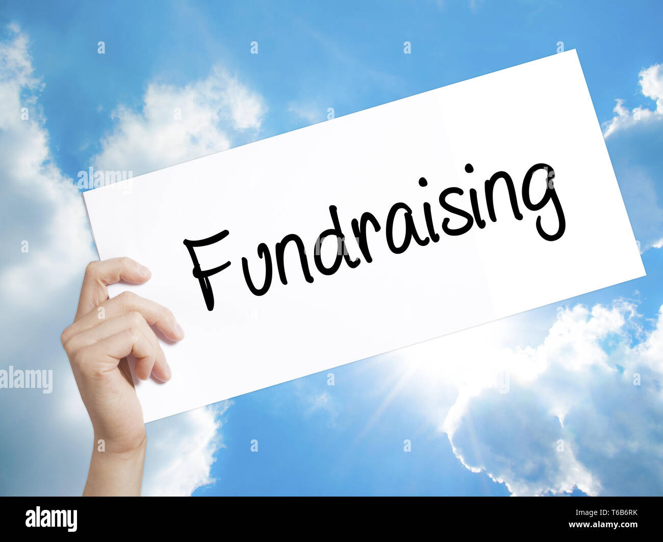 Fundraising Sign on white paper. Man Hand Holding Paper with text ...