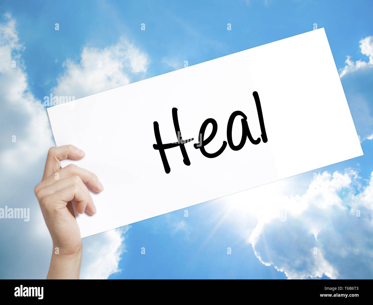Heal Sign on white paper. Man Hand Holding Paper with text. Isolated on ...