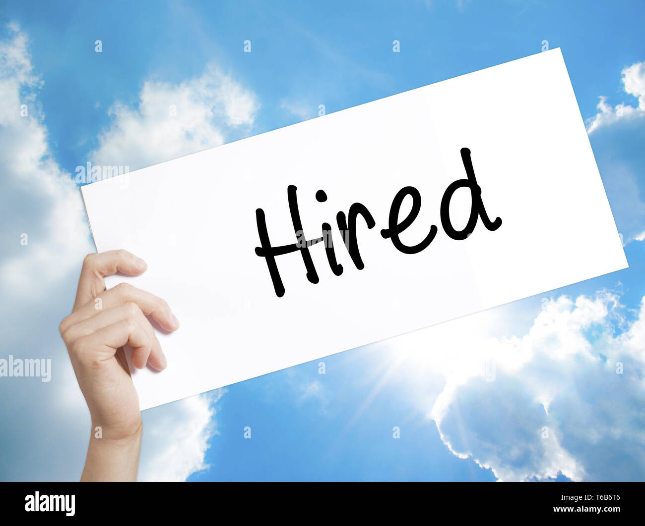 Hired Sign on white paper. Man Hand Holding Paper with text. Isolated ...