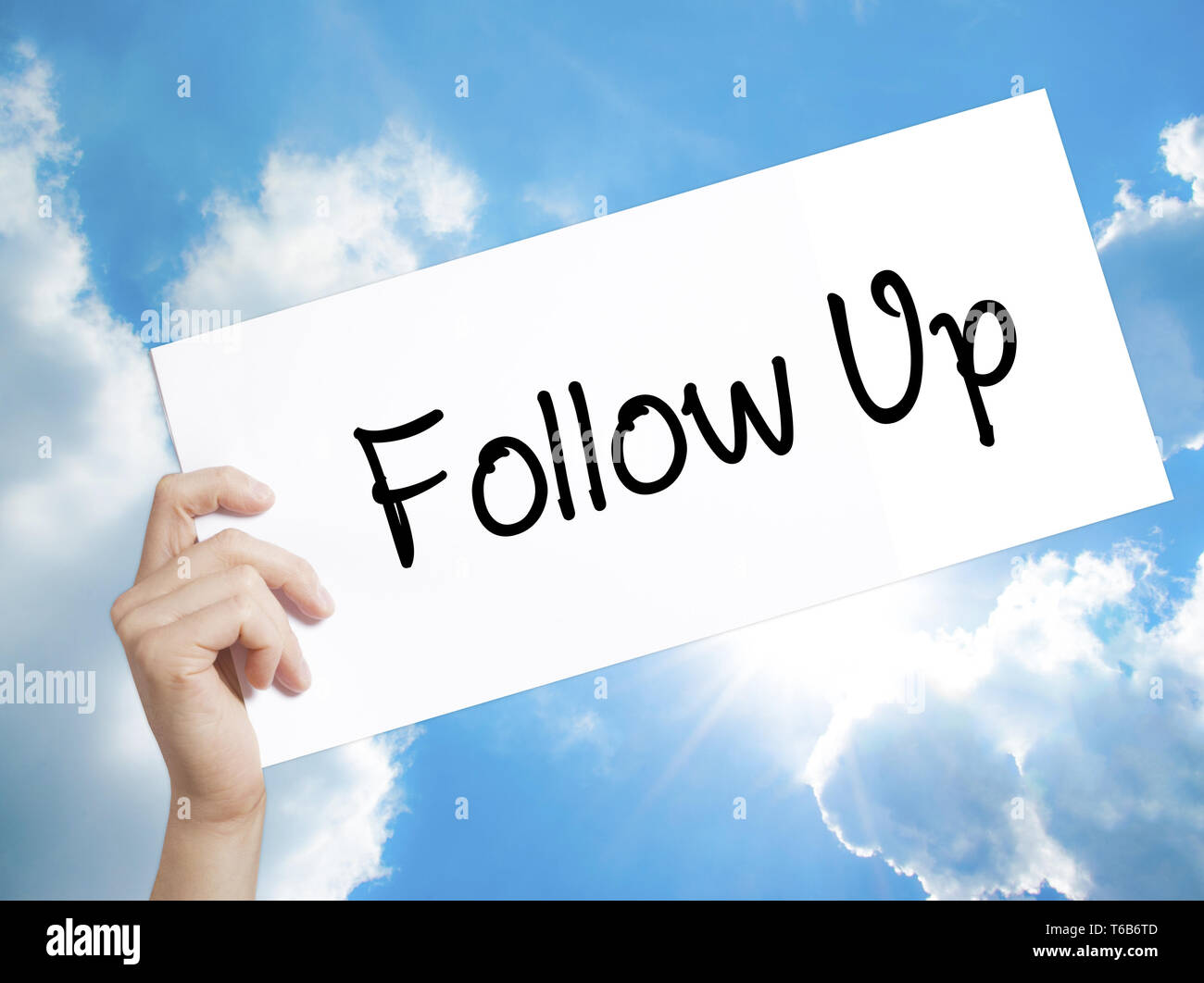 Follow Up Sign on white paper. Man Hand Holding Paper with text ...