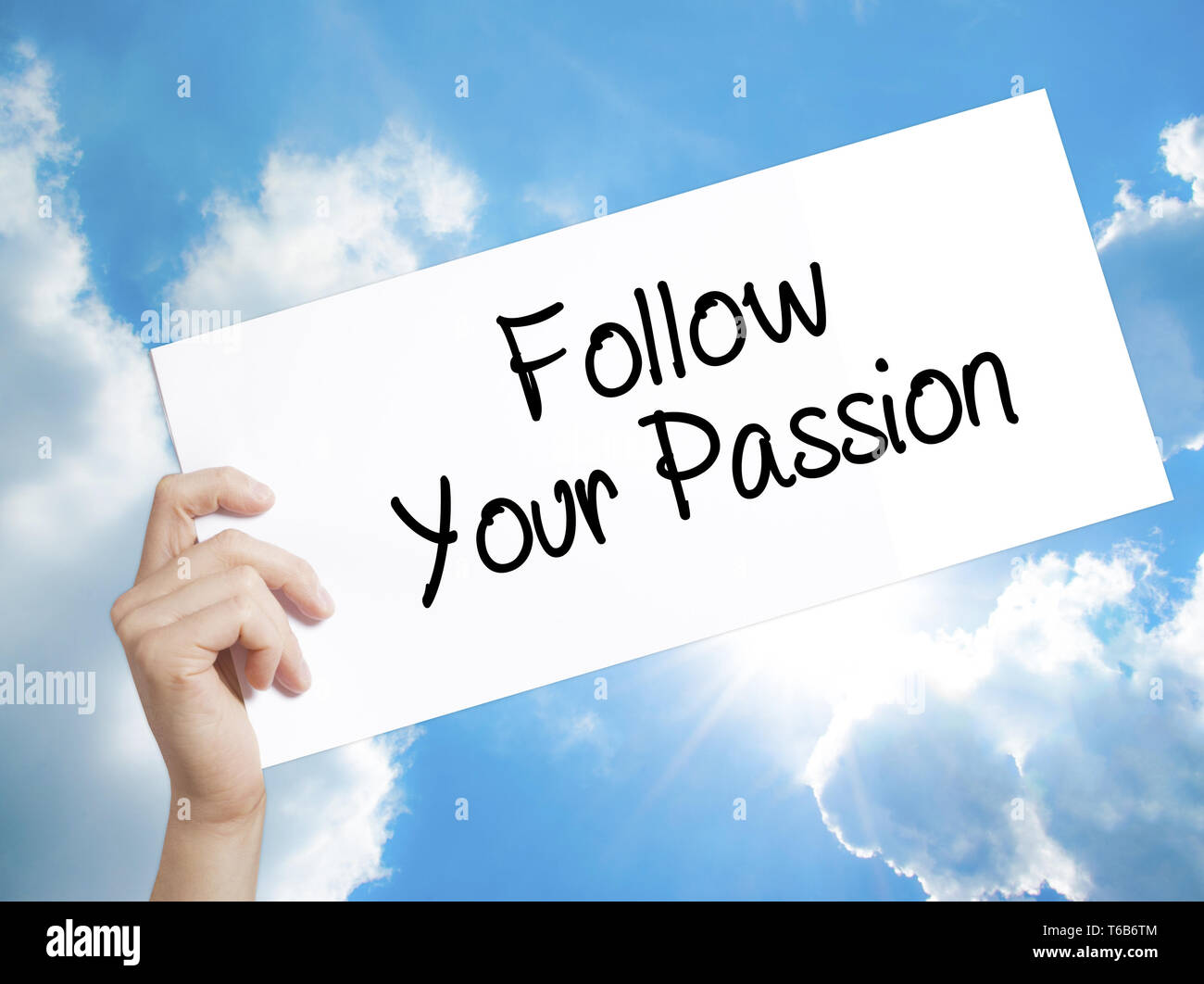 Follow Your Passion Sign on white paper. Man Hand Holding Paper with ...