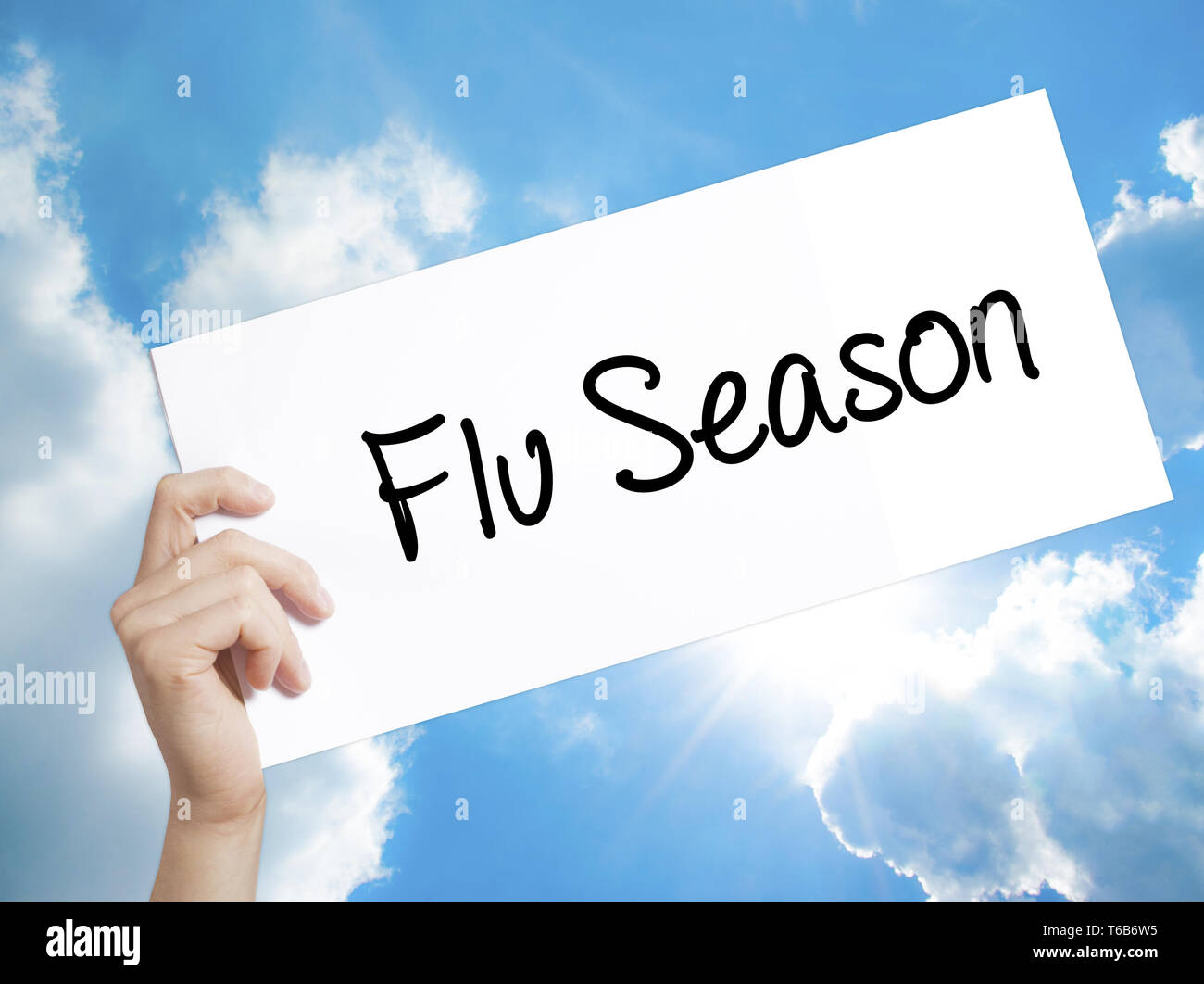 Flu Season Sign on white paper. Man Hand Holding Paper with text ...