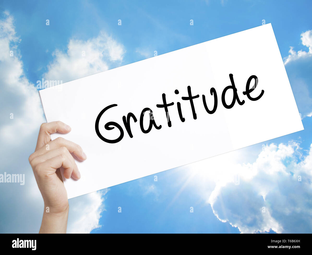 Gratitude Sign on white paper. Man Hand Holding Paper with text ...