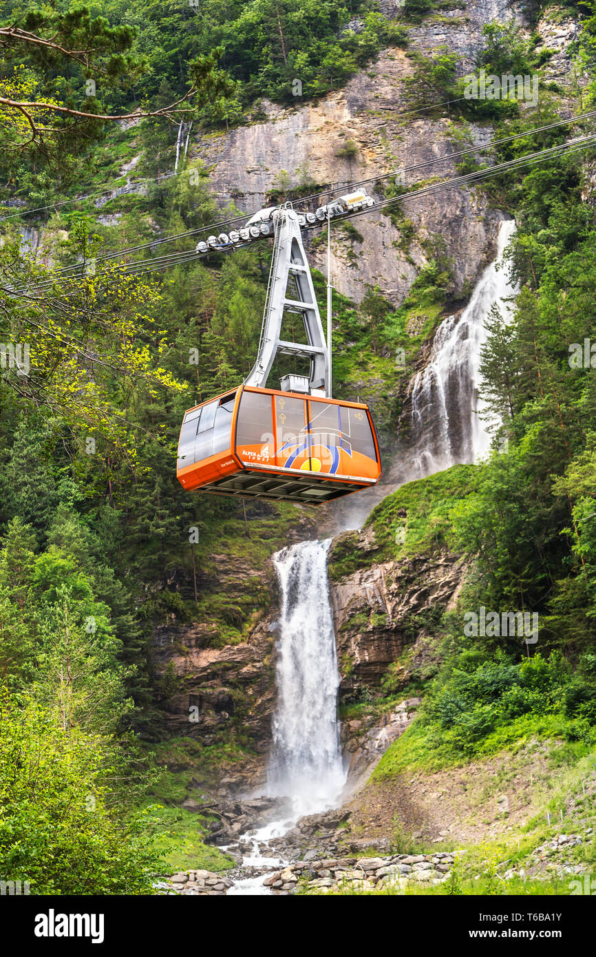 Red cable car on the background of a waterfall Stock Photo - Alamy