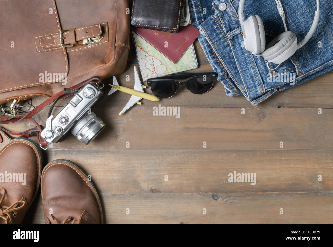 prepare backpack accessories and travel items on wood background with ...