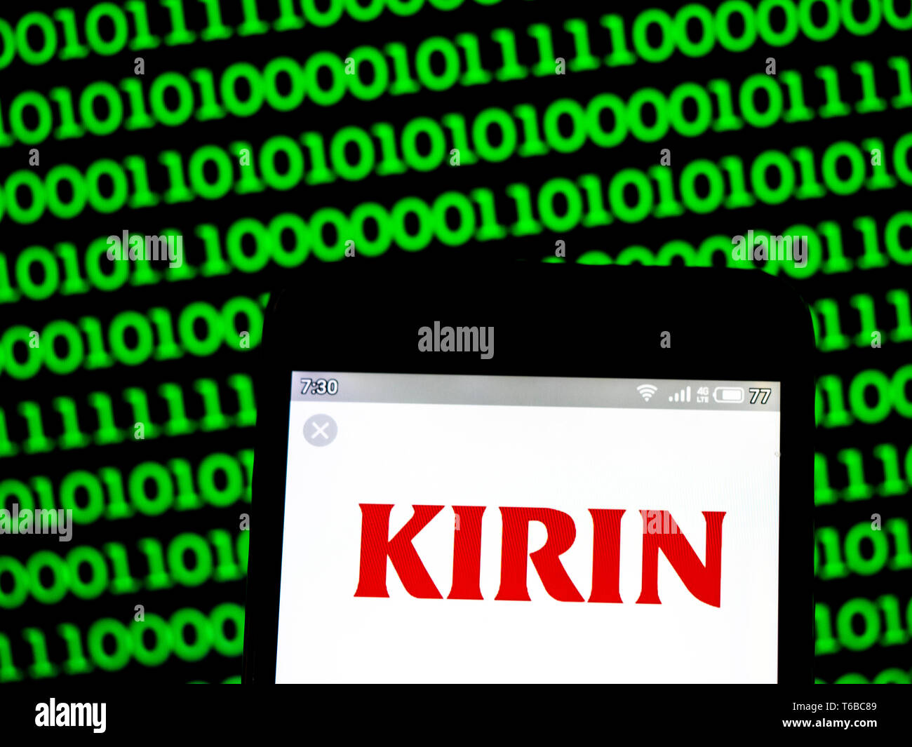 In this photo illustration a Kirin Company, Limited logo seen displayed on a smart phone Stock ...