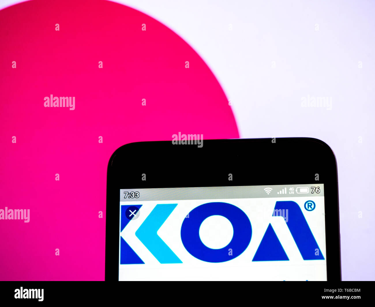 In this photo illustration a KOA Corporation logo seen displayed on a ...