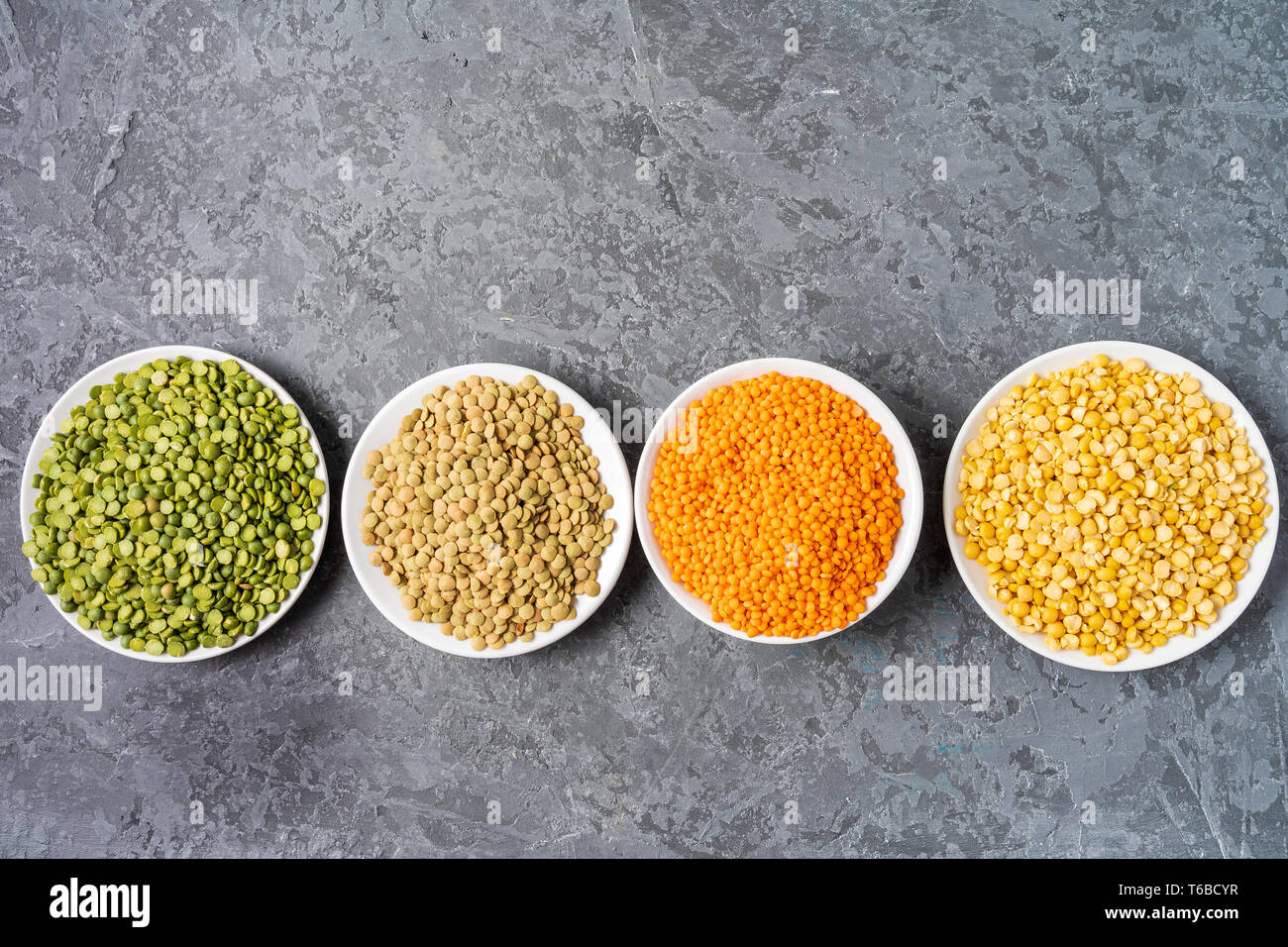 Top view of assortment of peas, lentils and legumes over gray ...
